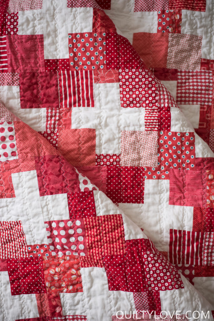 Red Scrappy Swiss Plus Quilt - Quilty Love