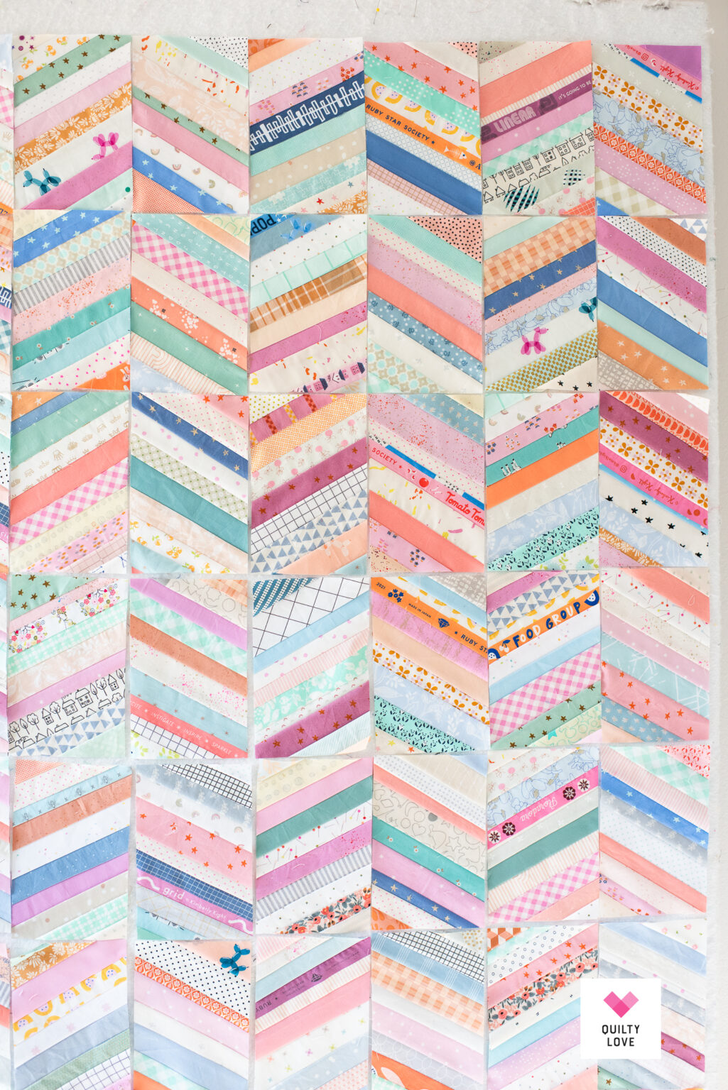 Pastel Scrappy String quilt - Quilty Love