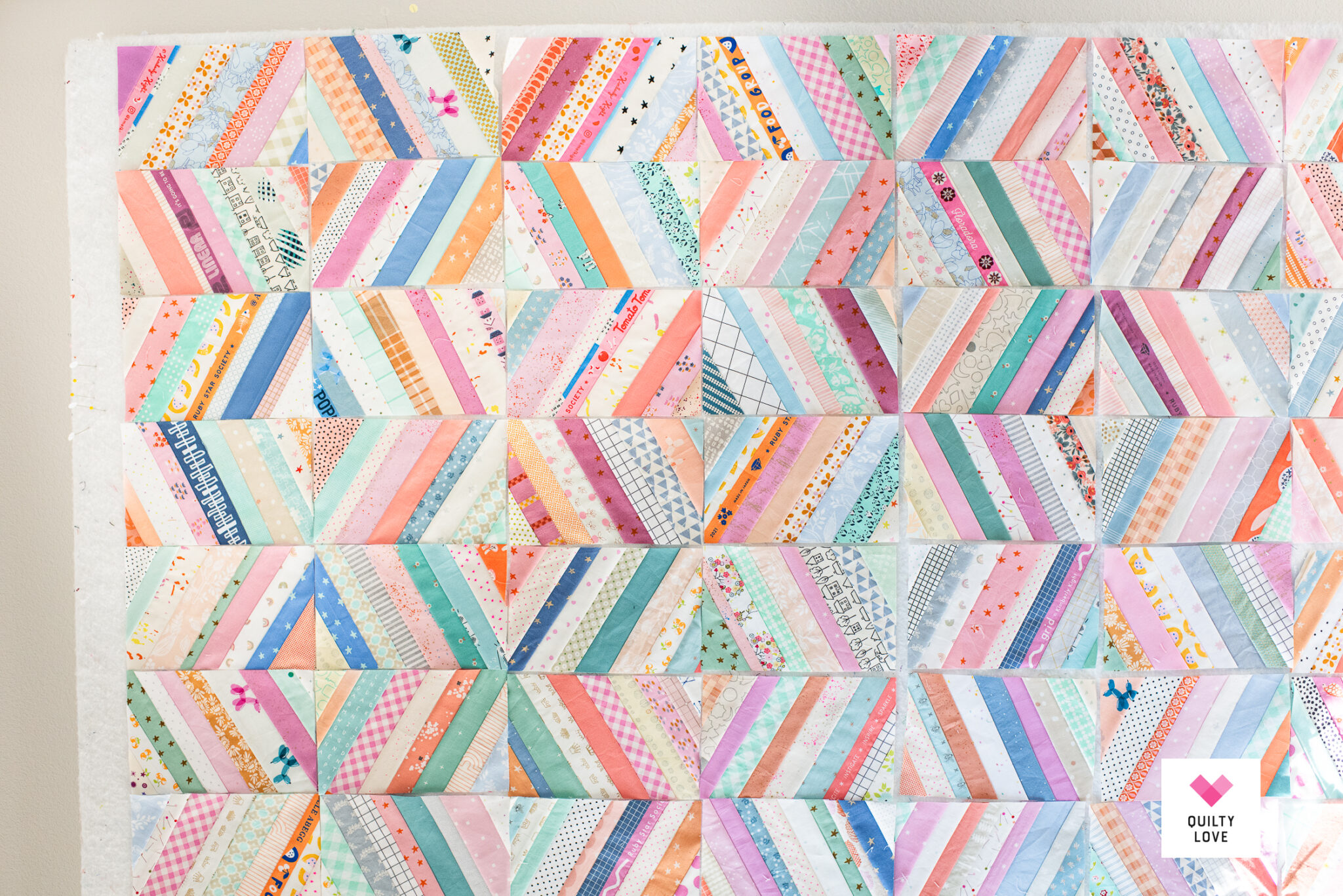 Pastel Scrappy String quilt - Quilty Love