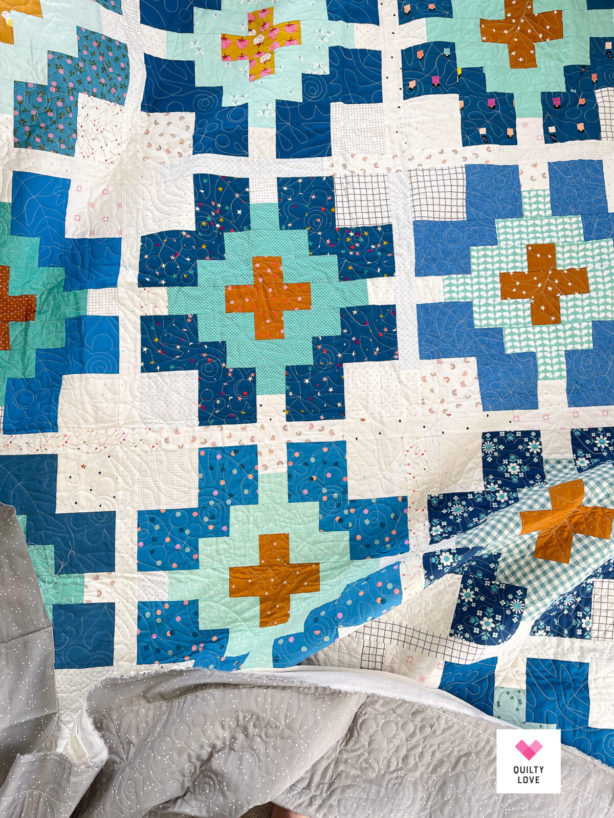 Scrappy Glowing quilt with scrappy low volume background - Quilty Love