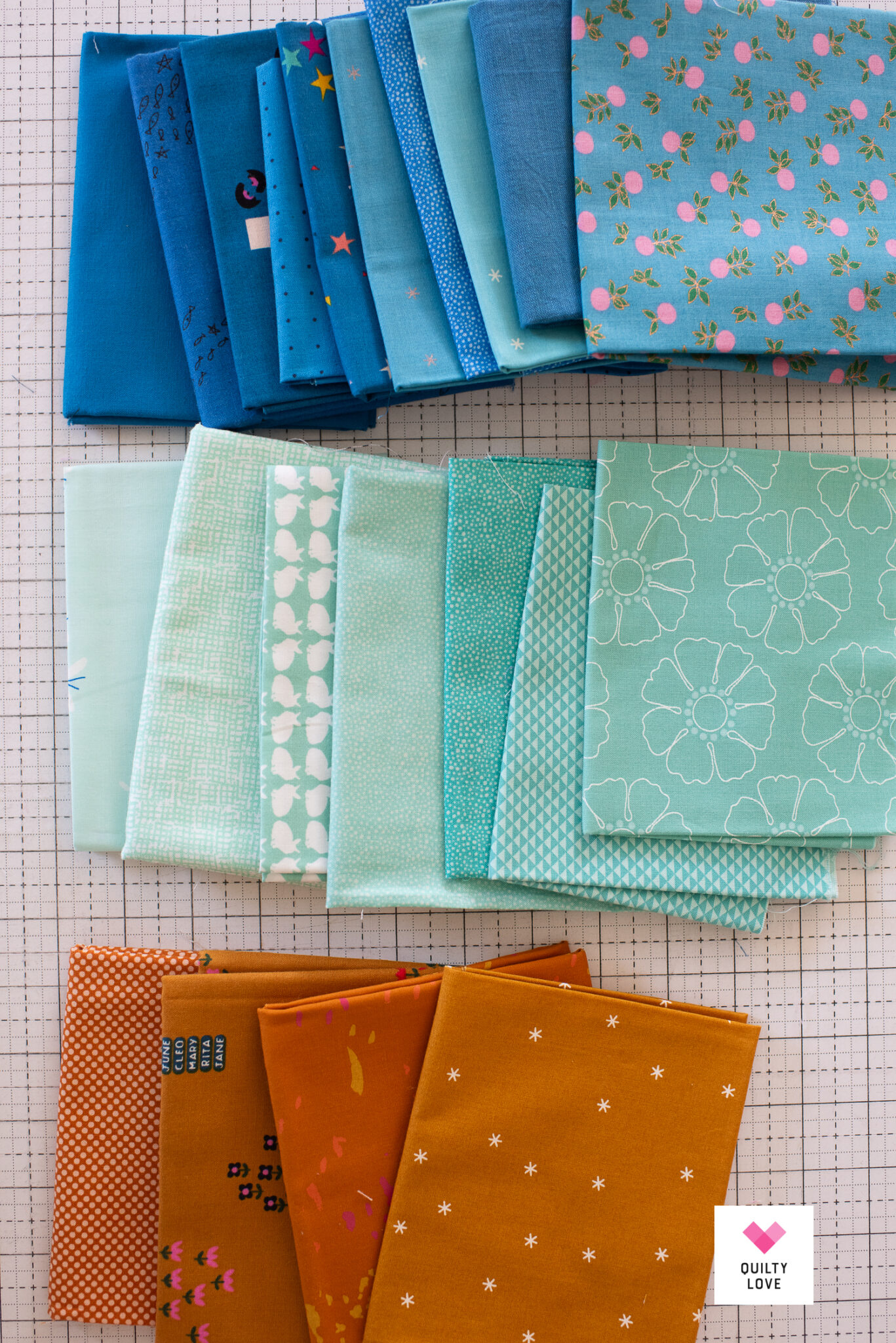 Scrappy Glowing quilt with scrappy low volume background - Quilty Love