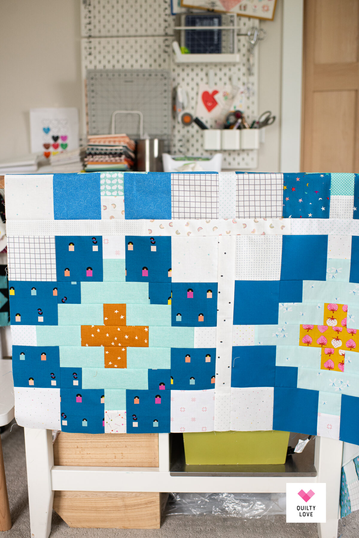 Scrappy Glowing quilt with scrappy low volume background - Quilty Love