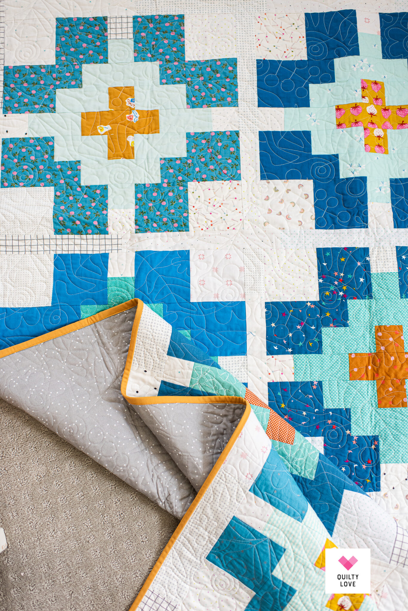 Scrappy Glowing quilt with scrappy low volume background - Quilty Love