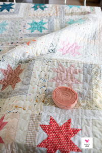 Rainbow Scrap Stash Log Cabin Stars quilt - Quilty Love