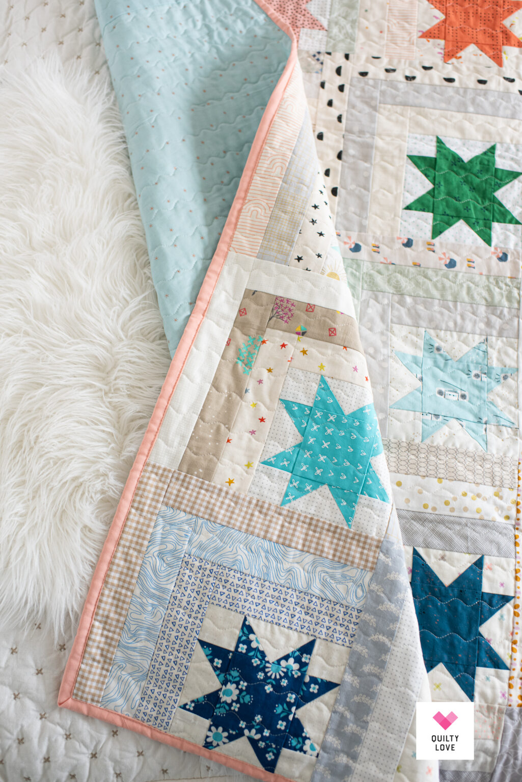 Rainbow Scrap Stash Log Cabin Stars quilt - Quilty Love